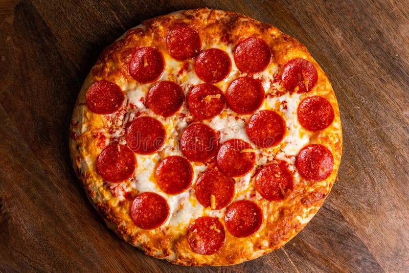 Top View of a Delicious Pepperoni Pizza on a Wooden Table Stock Photo ...