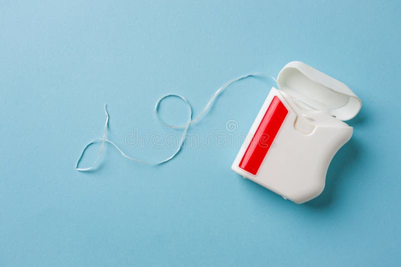 Top View of Dental Floss in White Box on Blue Background Stock Photo ...