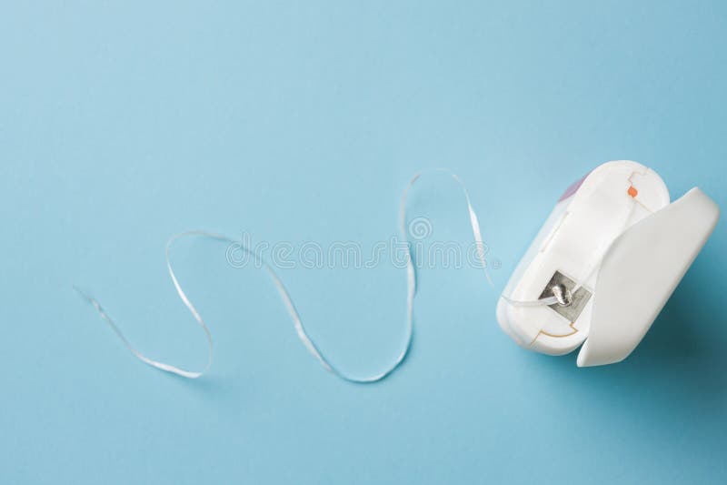 Top View of Dental Floss in White Box on Blue Background Stock Photo ...