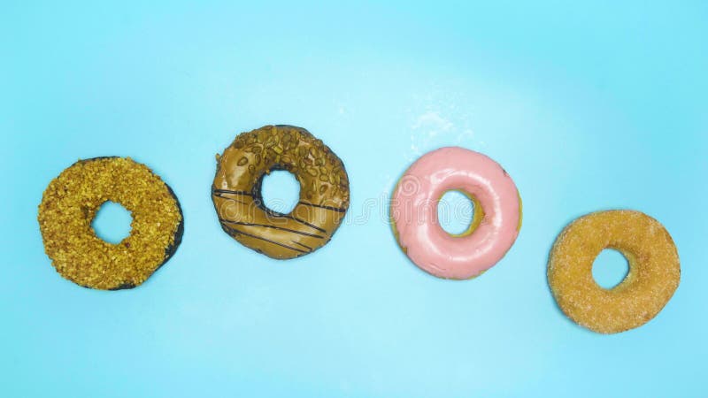 Top View Different Donuts Colors Changing at Blue Background. Stop ...