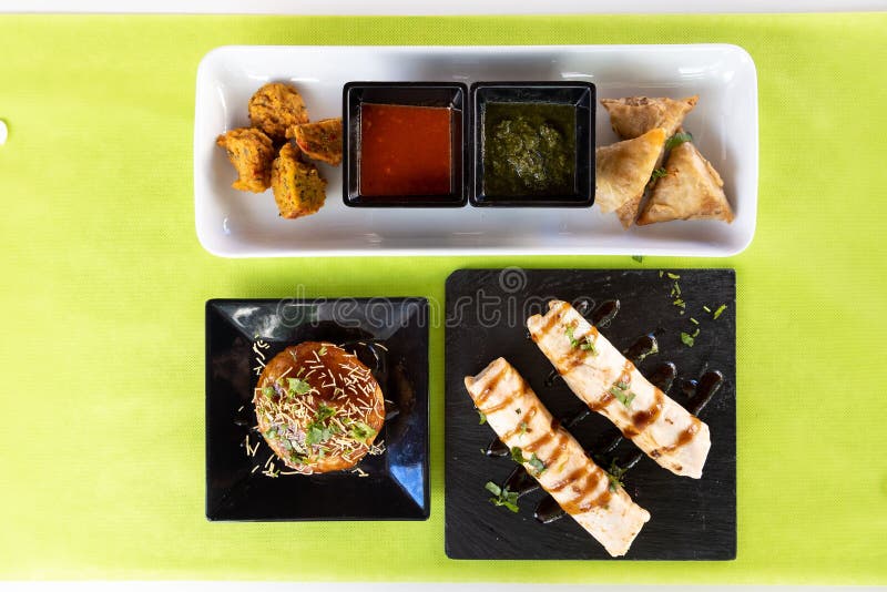 Top View of Different Indian Dishes on White Table with Green ...