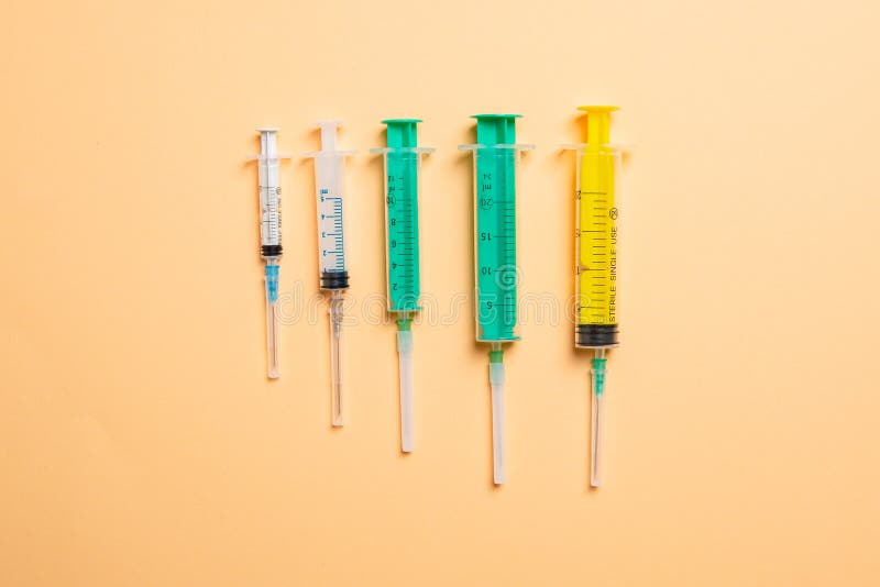 Top View of Different Syringes at Orange Background. Medical Injection ...