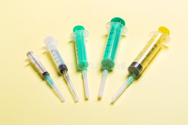 Top View of Different Syringes at Yellow Background. Medical Injection ...