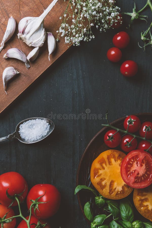 Top View of Different Tomatoes, Garlic and Salt on Wooden Tabletop ...