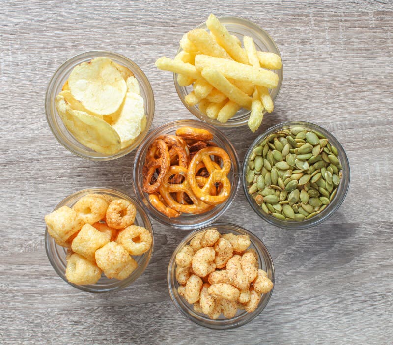 Top View of Different Types of Snacks on Wooden Table. Crisps and ...