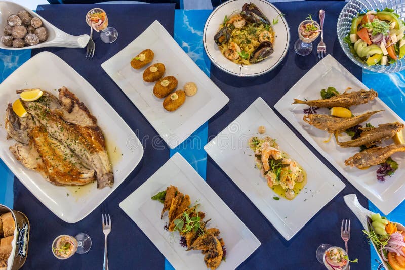 Top View of a Dining Table with Different Dishes with Seafood, Meat ...