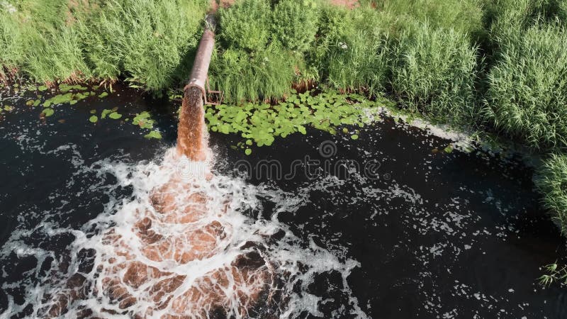 Top View of Dirty Water Flowing from a Rusty Pipe into the River Stock ...