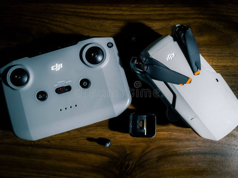 Top View of a DJI Mini 2 Drone and Controller on a Wooden Table ...
