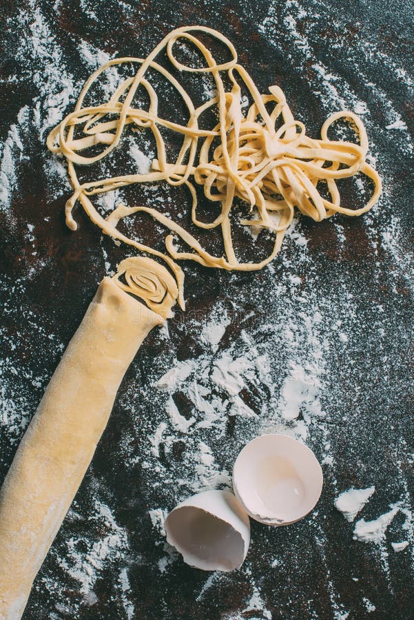 Top View Of Dough, Egg Shell And Raw Pasta On Table Covered Stock Image ...