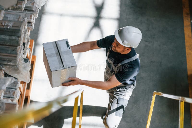 Leaning on the Box and Smiling. Employee in Uniform is Working in the ...