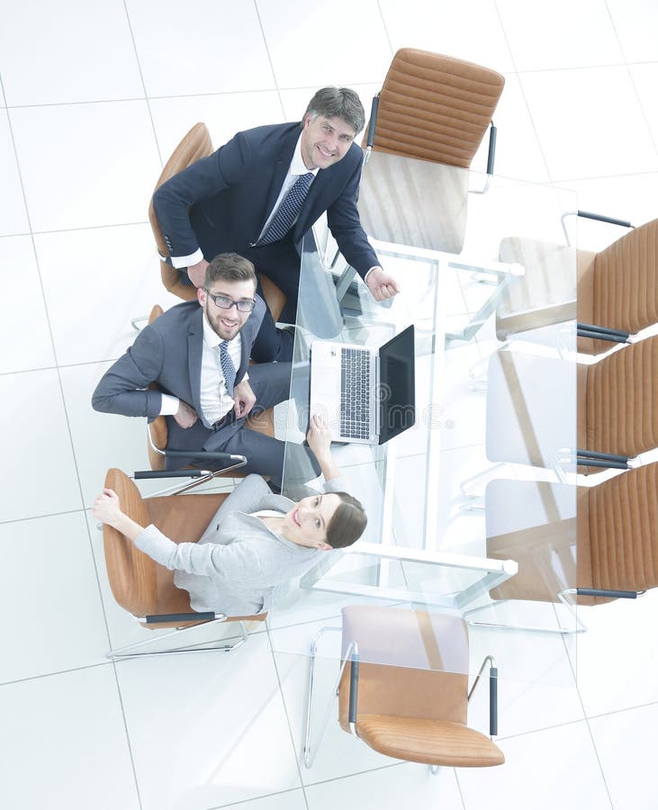 Employees Sitting at the Desk and Looking Up Stock Image - Image of ...