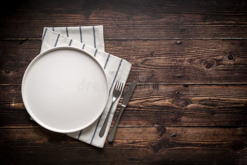 Top View of Empty Ceramic White Plate, Fork and Table Knife on Wooden ...