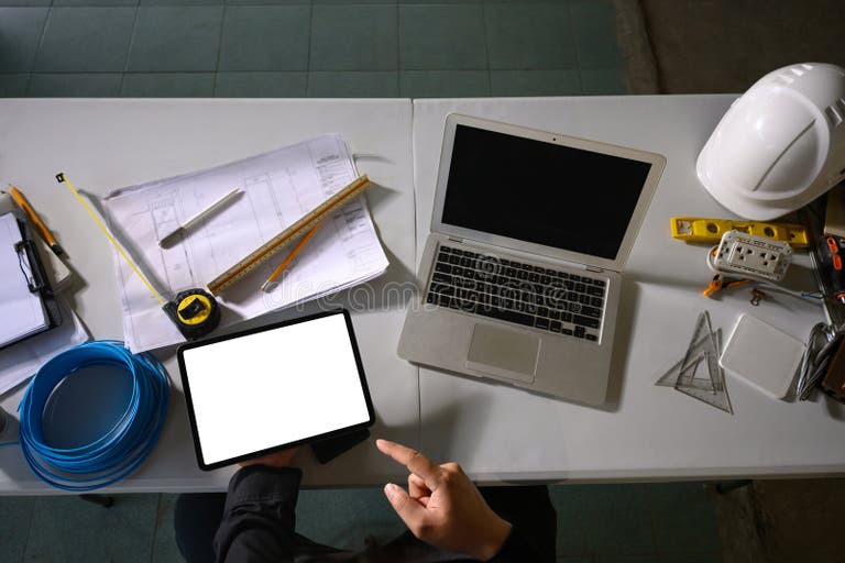 Top View of Engineer Using Digital Tablet at Desk Surrounded by ...