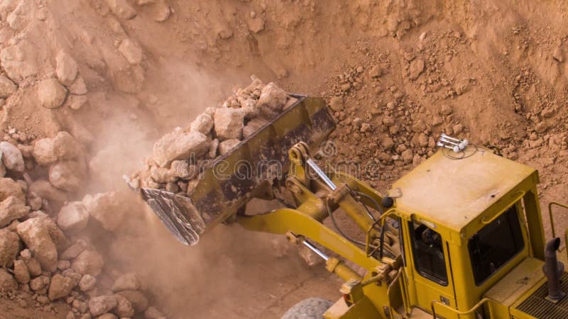 Top View Excavator Loading Crushed Rock on Dumper Truck Stock Video ...