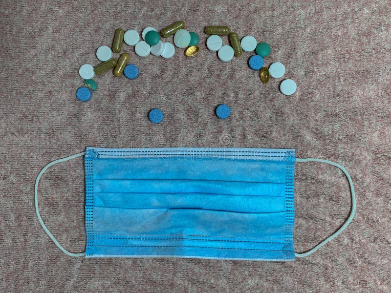 Top View of a Face Mask and Capsules and Pills- COVID-19 Stock Image ...