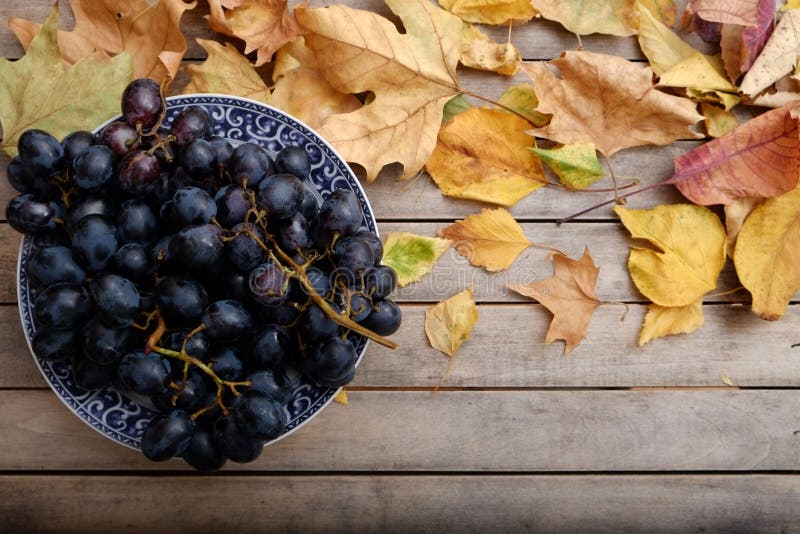 Top View of Fall Leaves and Grapes on a Wooden Table Stock Photo ...