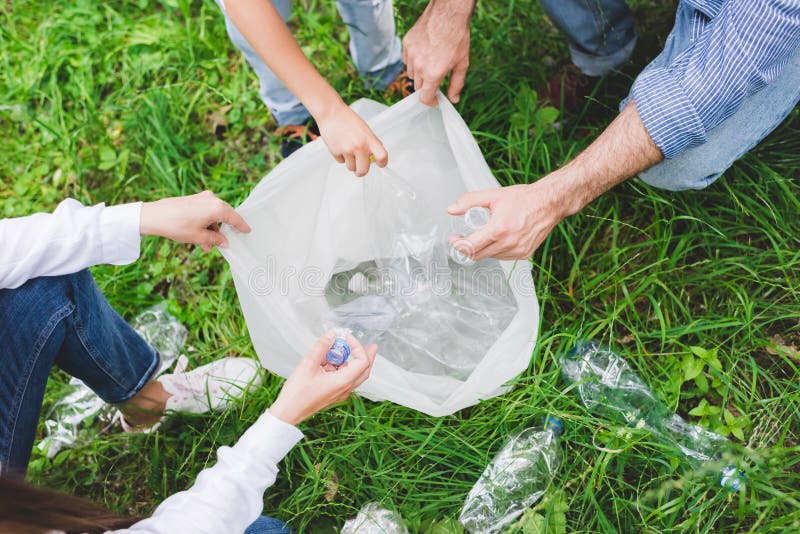 View of Family Putting Garbage in Plastic Bag in Park Stock Image ...