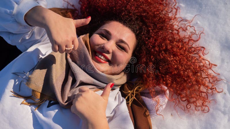 Top View of a Fat Red-haired Woman Lying on the Snow. Stock Photo ...