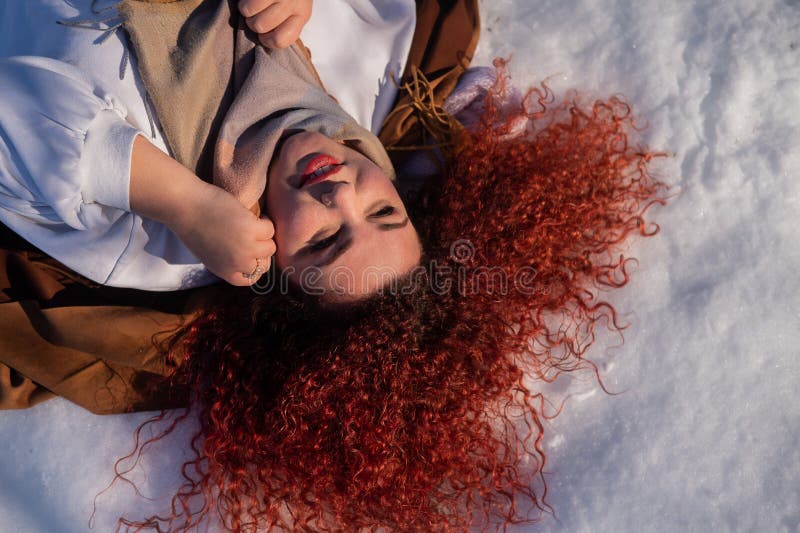 Top View of a Fat Red-haired Woman Lying on the Snow. Stock Photo ...