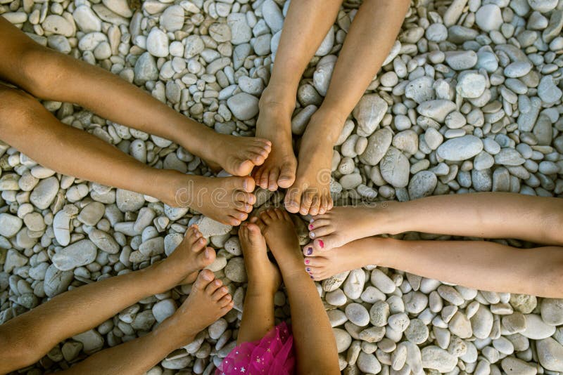 Kids feet on pebble beach stock image. Image of little - 156802413
