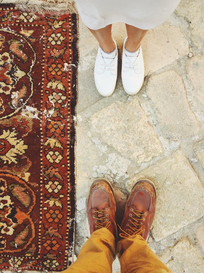 Top View of Feet of Young Couple on Ground with a Piece of Carpet by ...