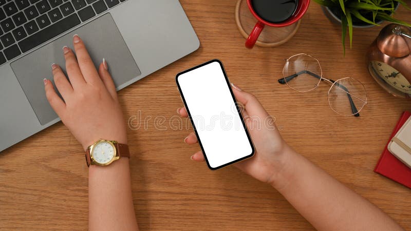 Female Looking at Smartphone Screen and Typing on Laptop Stock Image ...