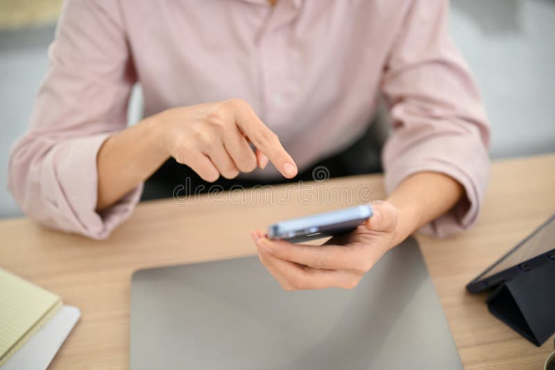 Top View of a Female Office Worker Using a Smartphone at Her Desk ...