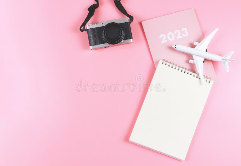 Flat Lay of Blank Paper Note Book on Pink Diary 2023 with Airplane Model and Camera on Pink ...
