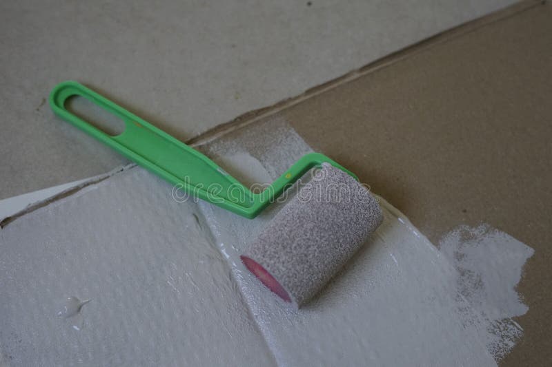 Top View of Foam Paint Roller with Green Plastic Handle in Paint Stock ...