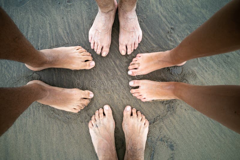 Top View of Four Barefoot People on the Sand Stock Photo - Image of ...