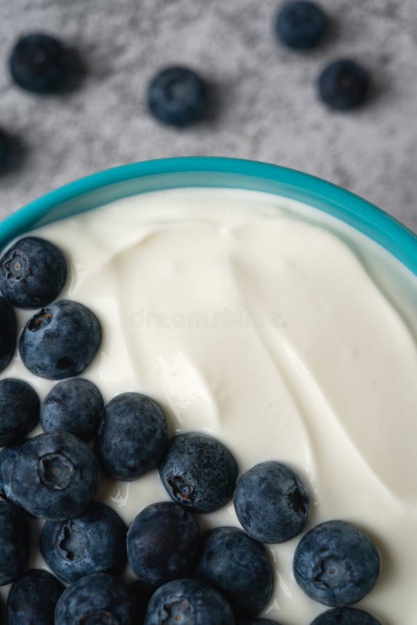 Top View of Fresh Blueberries on Creamy Yogurt in a Blue Bowl Stock ...