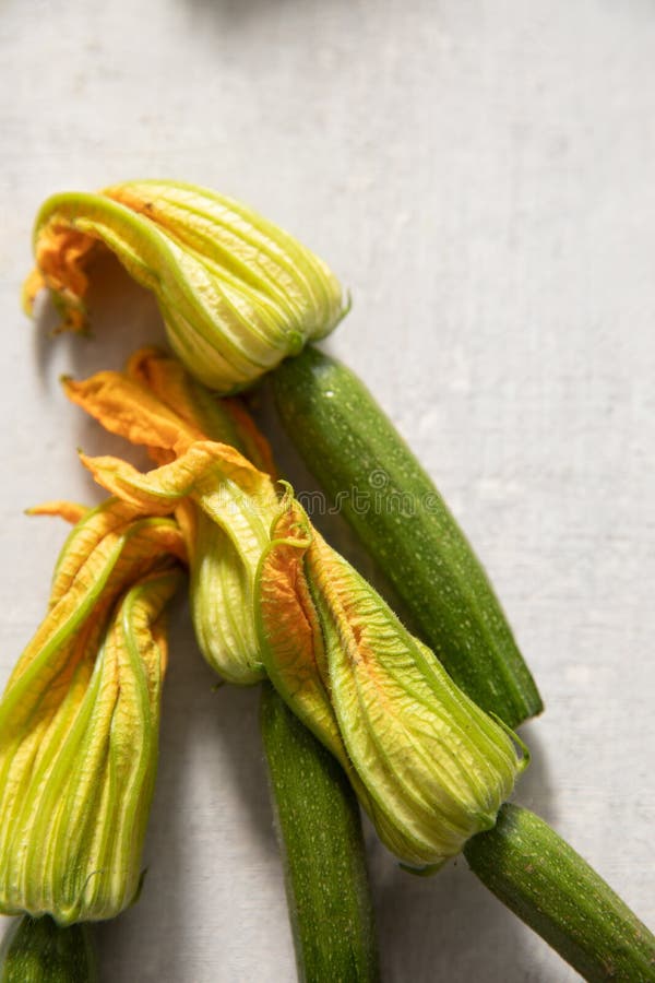 Top View of Fresh Courgettes or Zucchini with Flowers on a White ...