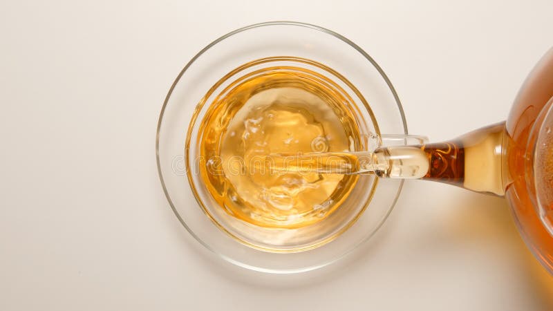 TOP VIEW: Fresh Tea Flowing To a Tea Cup from a Teapot Stock Photo ...