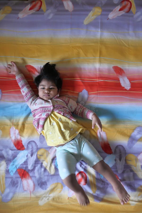Top View of Full Body Baby Child Laying Down on Bed Stock Photo - Image ...