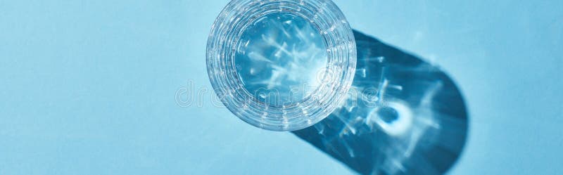 Top View of Glass with Clear Water on Blue Background with Shadow ...