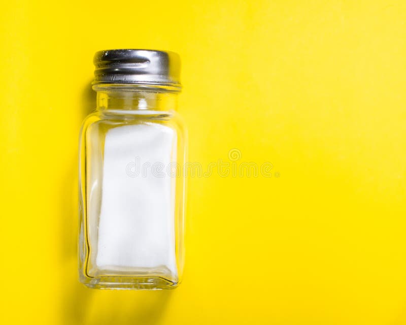 Top View of a Glass Salt Shaker Filled with Salt on a Yellow Surface ...