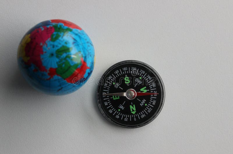 Top View of Globe Model and Compass on White Surface Stock Photo ...
