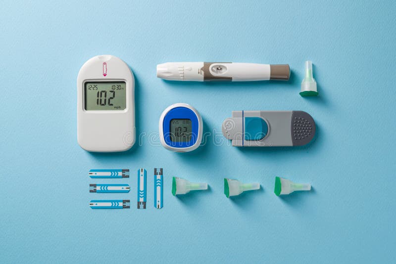 Top View of Glucometer, Lancet Pen and Strips on Blue Background ...