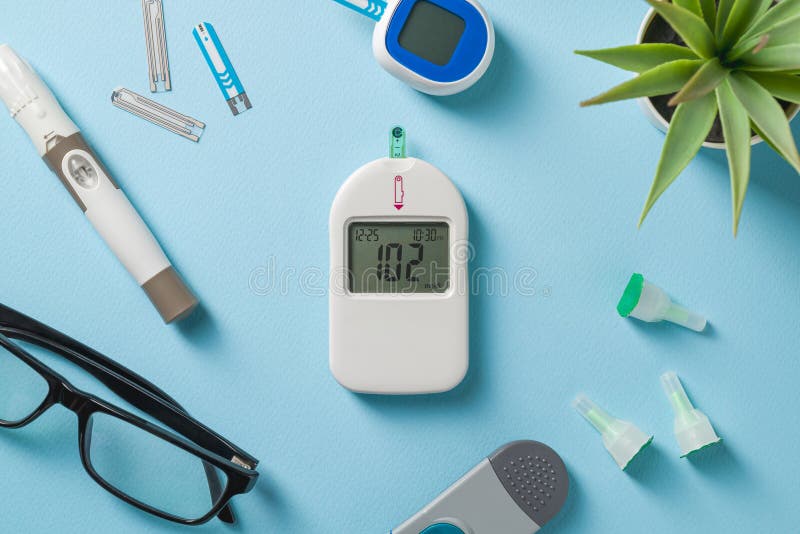 Top View of Glucometer, Lancet Pen and Strips on Blue Background ...