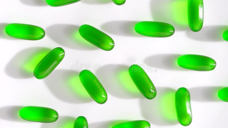 Top-view of Green Capsules of Vitamin E Scattered on a White Surface ...