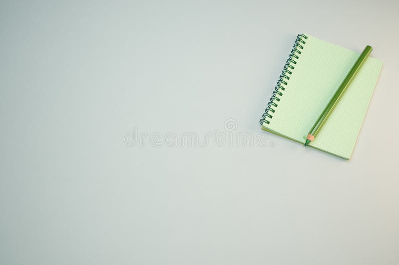 Top View of the Green Notepad and the Green Pencil on the Gray Surface ...