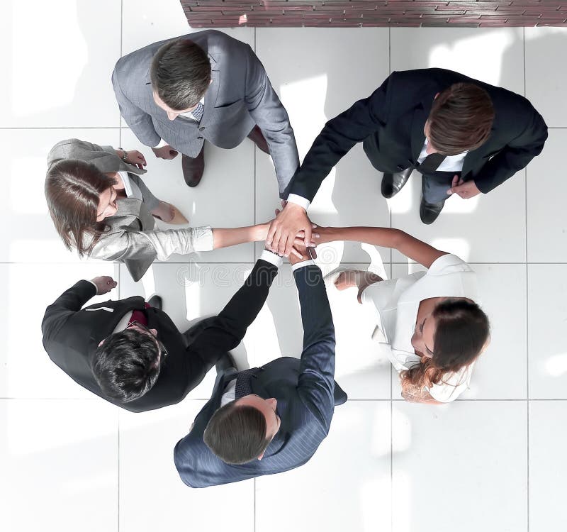 Top View. a Group of Business People with Their Hands Folded Together ...
