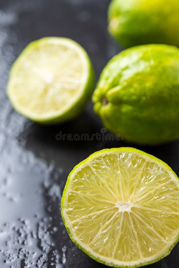 Top View of Half Lime and Wet Limes, on Stone Slate Background, with ...
