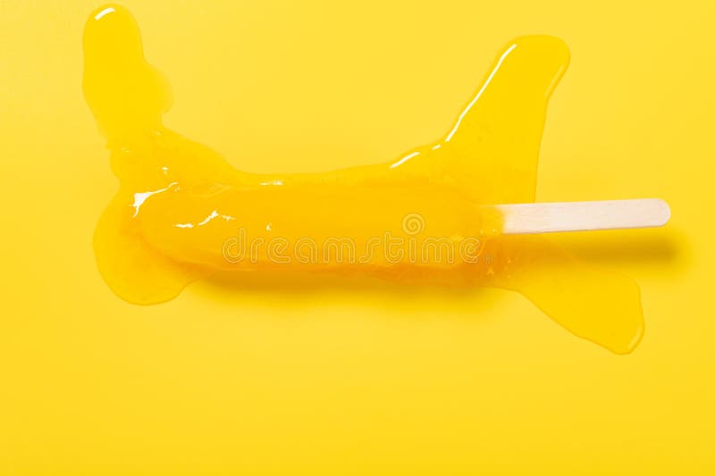 Half Melted Twisted Shaped Pineapple Flavor Popsicle on Yellow ...