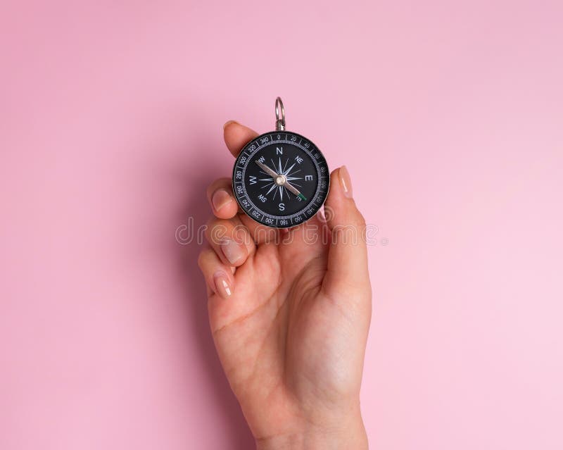 Top View of Hand Holding Compass on Pink Background, Searching ...