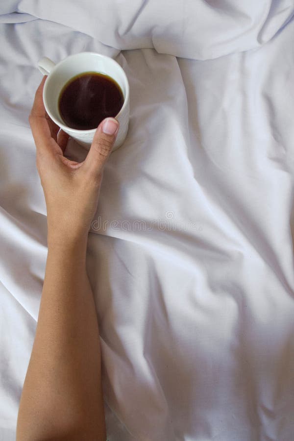 Top View of a Hand Holding a Drink in Ceramic Cup on White Cloth ...