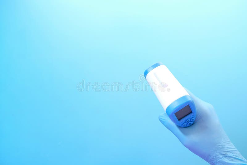 Top View Of Hand Holding Infrared Thermometer To Measuring Temperature