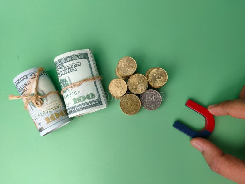 Top View Hand Holding Magnet with Coins and Banknotes Stock Photo ...