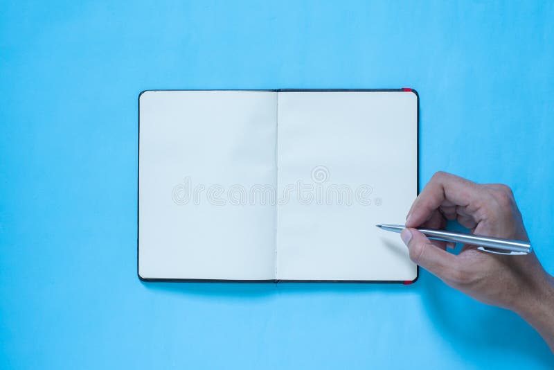 Top View of Hand and Notebook on Blue and Pinl Pastel Color Bakcground ...