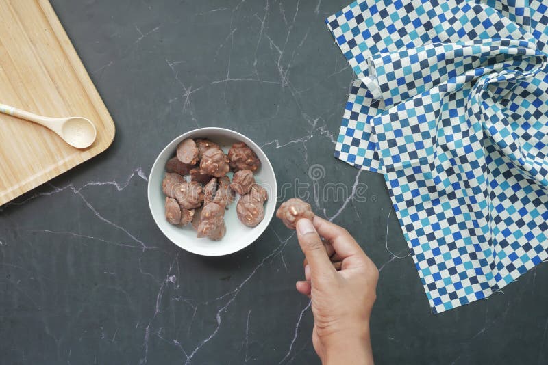 Top View of Hand Pick Peanut Chocolate Candy on Table Stock Photo ...